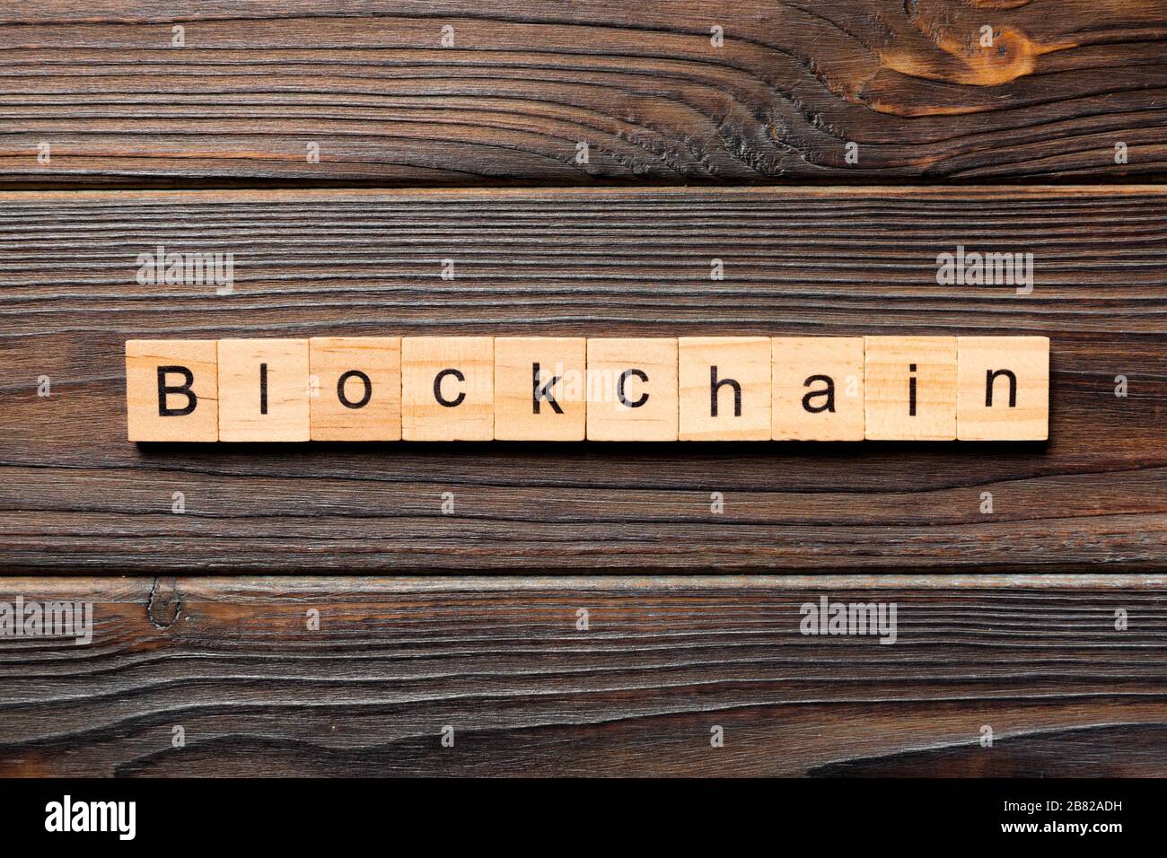 Blockchain word written on wood block. Blockchain text on wooden table ...