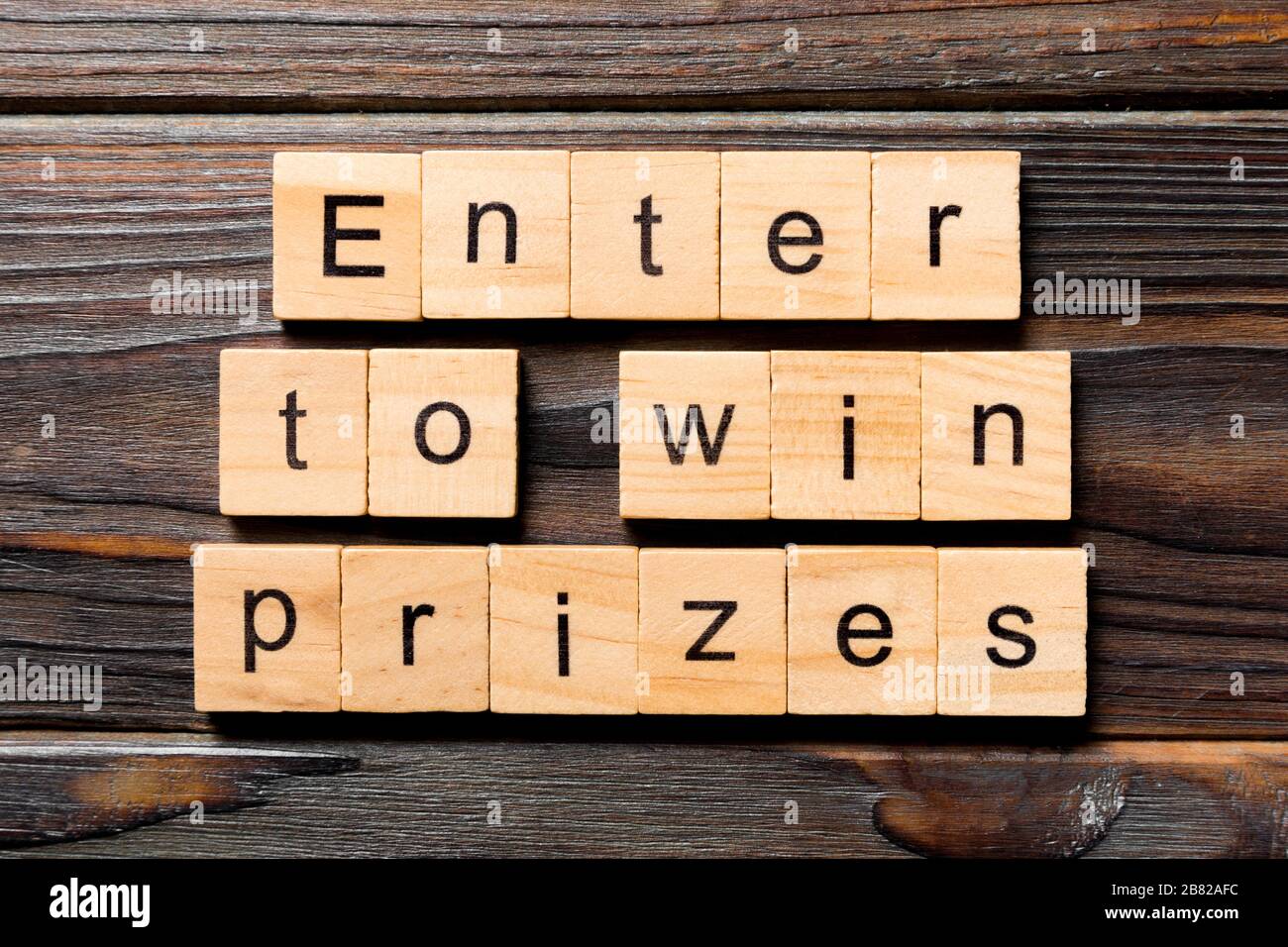 Enter to win prizes word written on wood block. Enter to win prizes ...