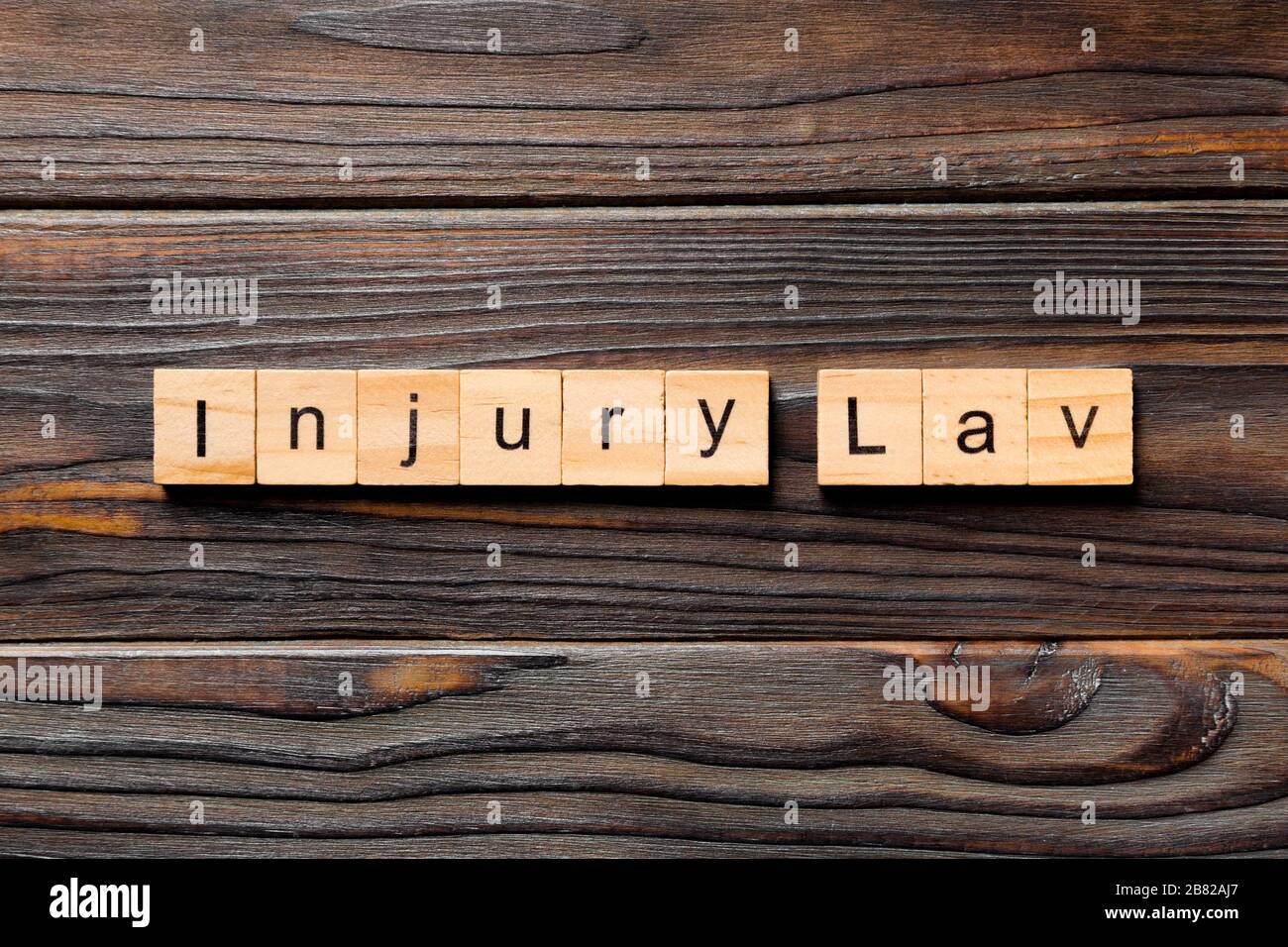 INJURY law word written on wood block. INJURY law text on table ...