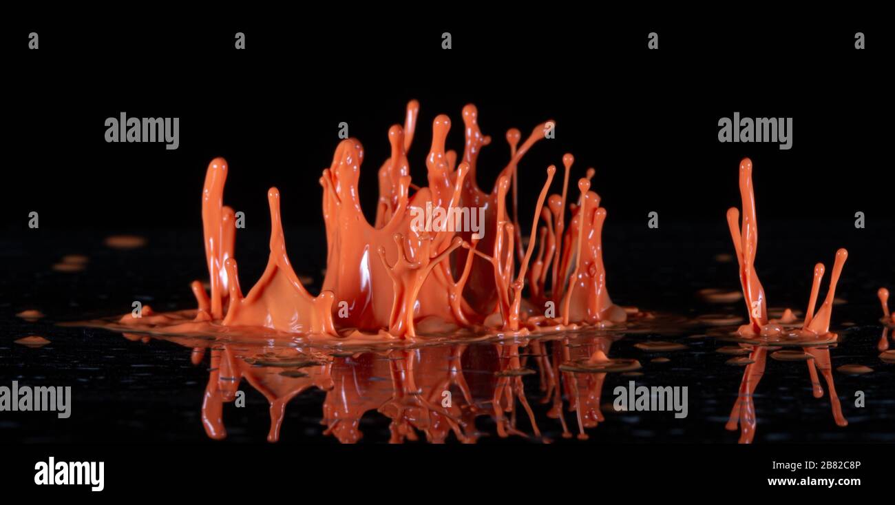 orange ink splash on a black background Stock Photo - Alamy