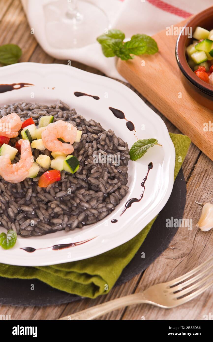 Squid ink risotto Stock Photo - Alamy