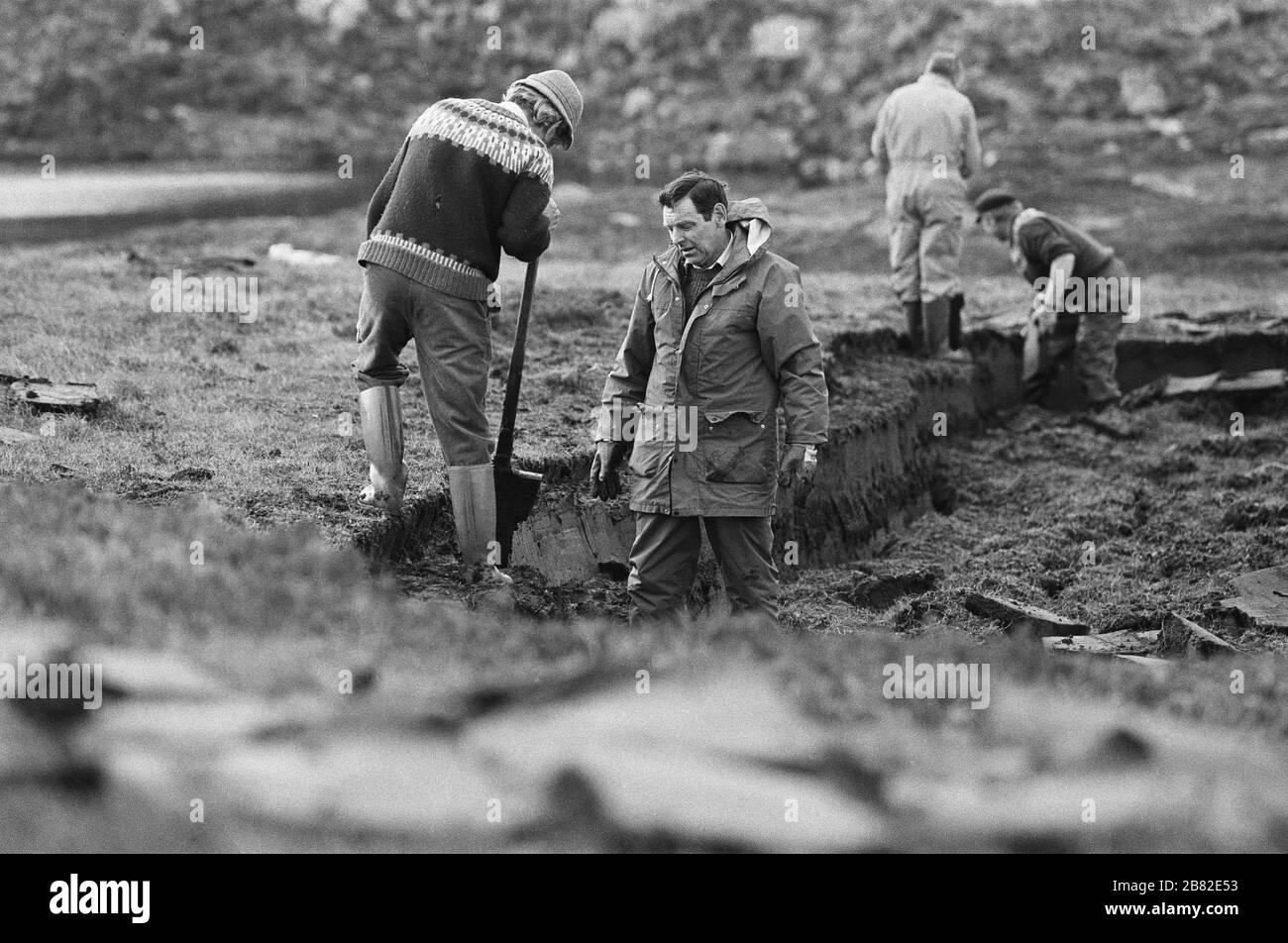 Men cutting peat on a stretch of land on the island of Lewis in the ...