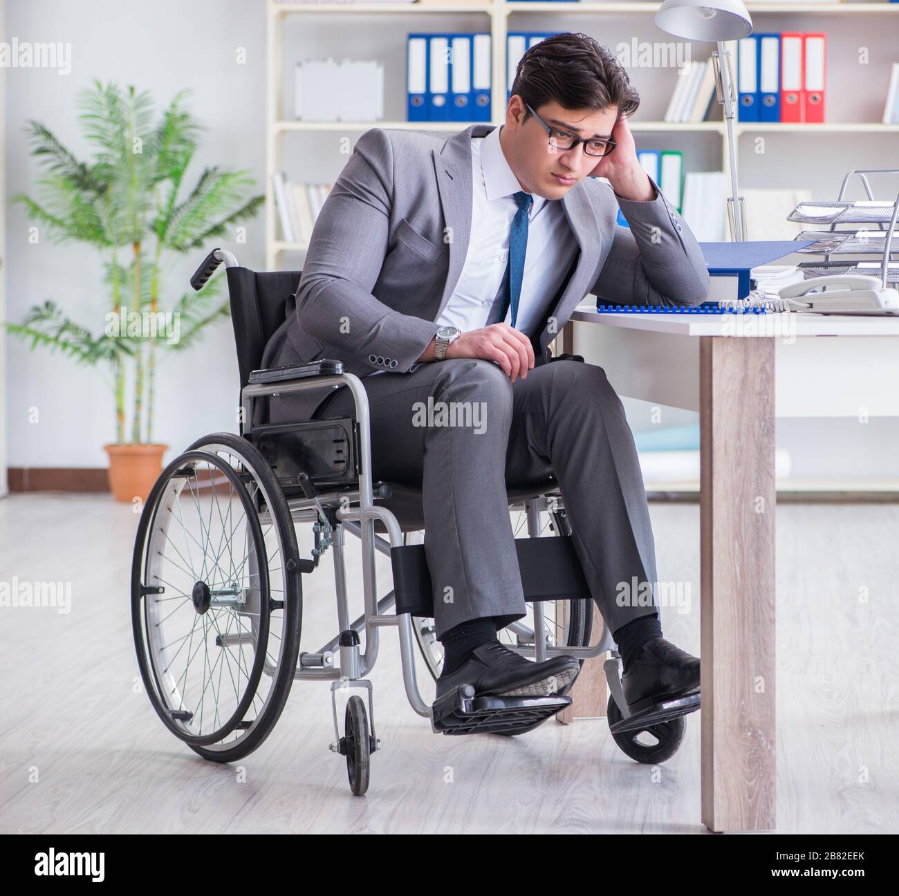The disabled businessman working in the office Stock Photo - Alamy