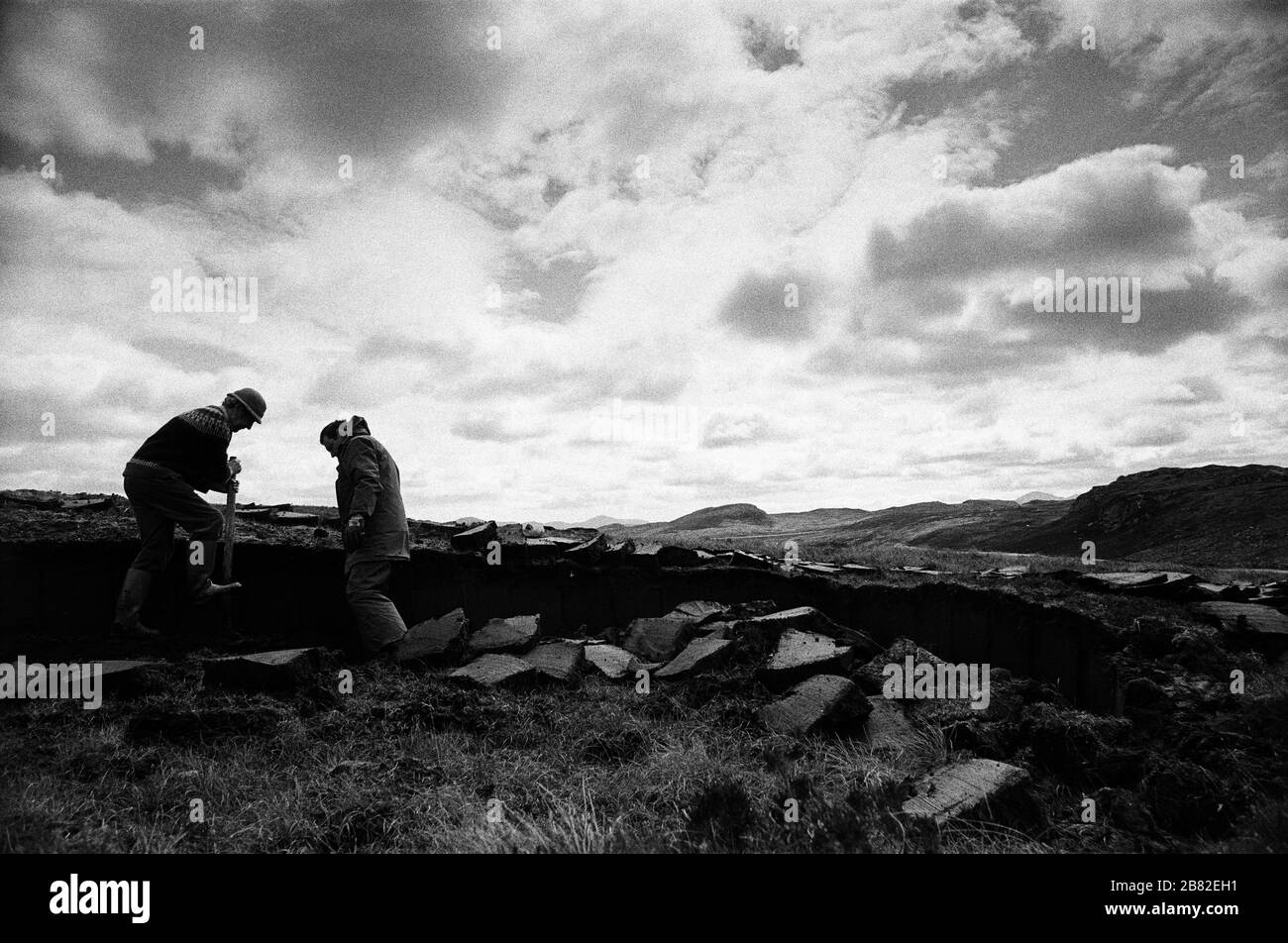 Men cutting peat on a stretch of land on the island of Lewis in the ...