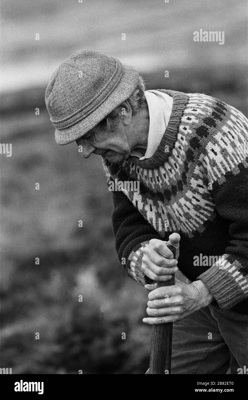 A man cutting peat on a stretch of land on the island of Lewis in the ...