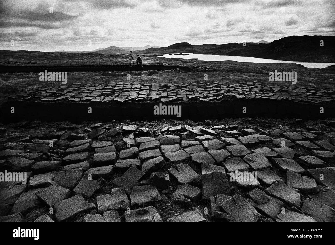 Men cutting peat on a stretch of land on the island of Lewis in the ...