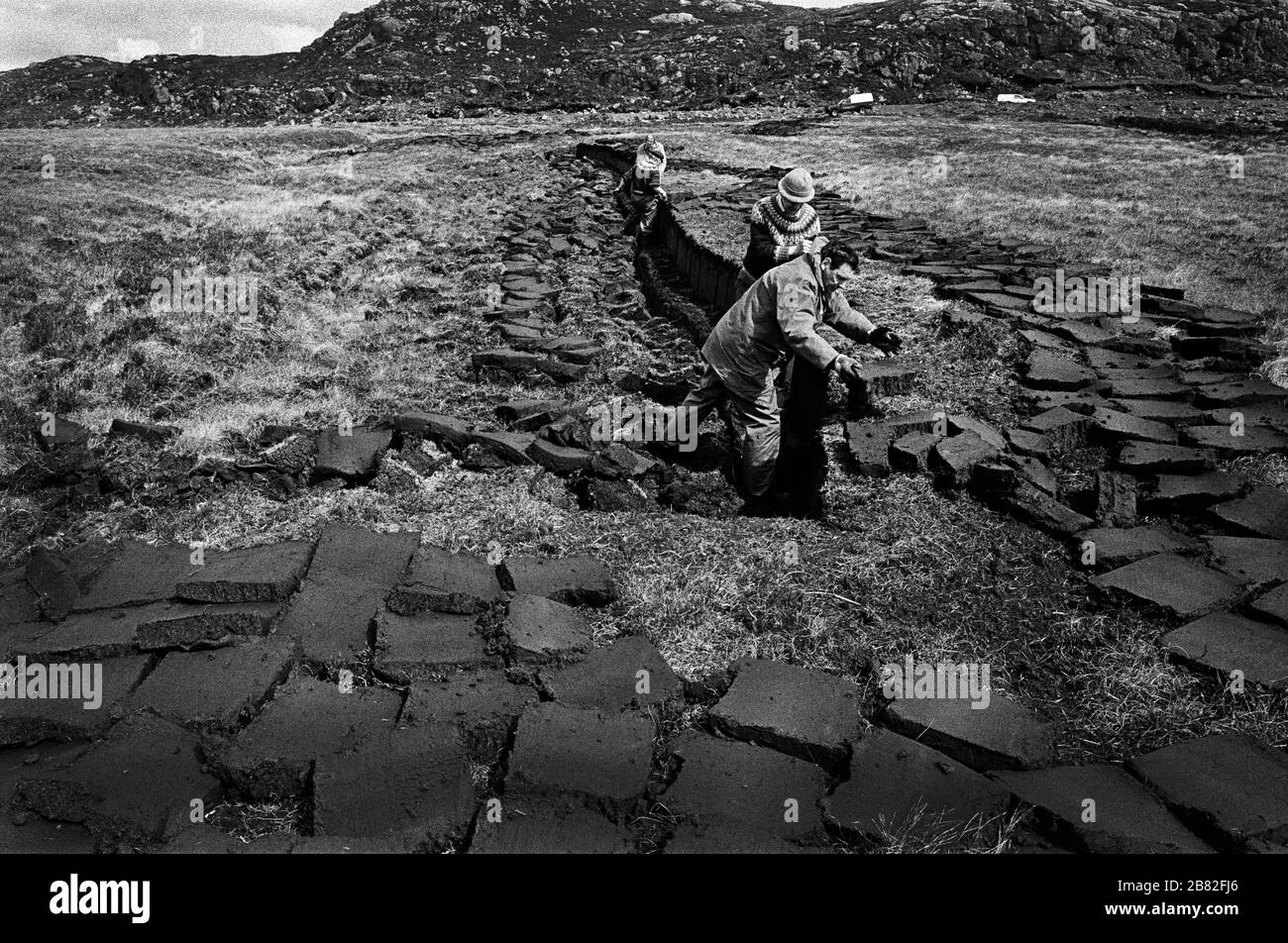 Men cutting peat on a stretch of land on the island of Lewis in the ...