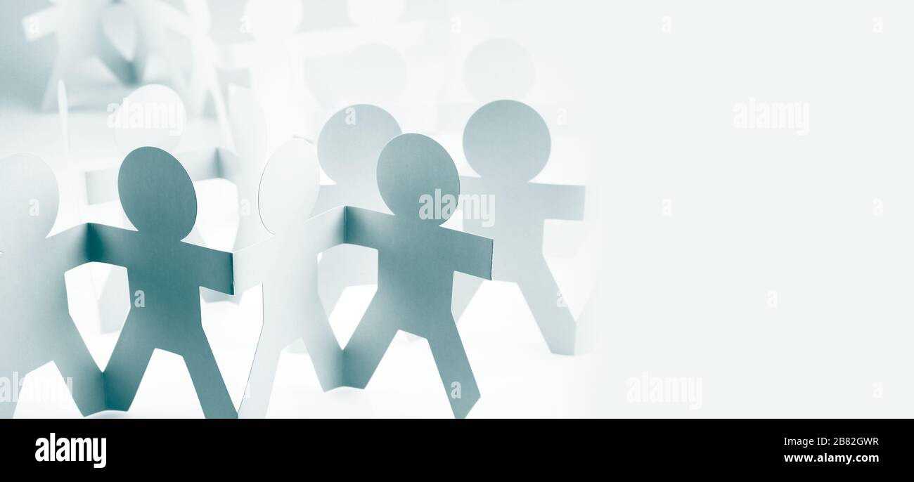 Paper chain team holding hands. Teamwork. Partnership Stock Photo - Alamy