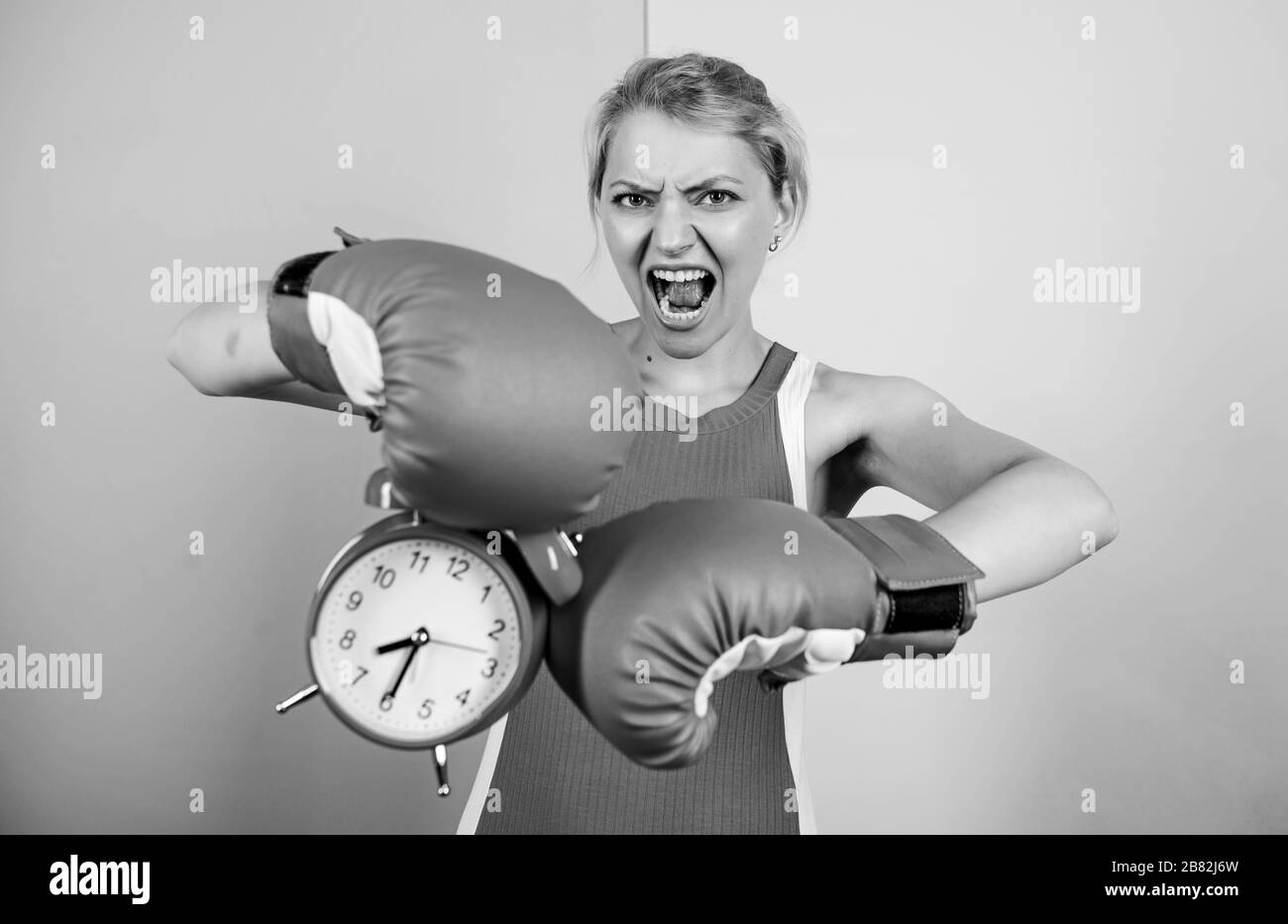punching a clock. time for success. win the day. angry woman boxing ...