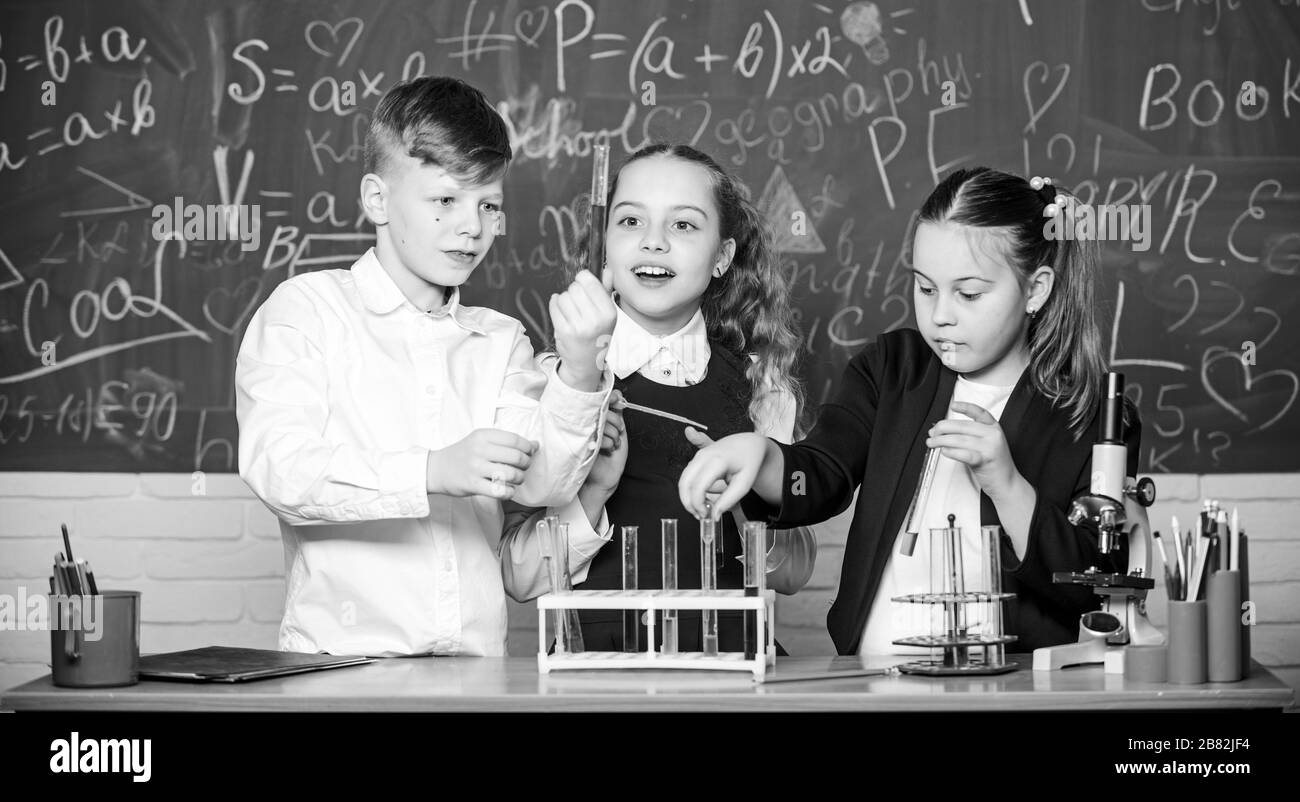Girls and boy student conduct school experiment with liquids. Check ...