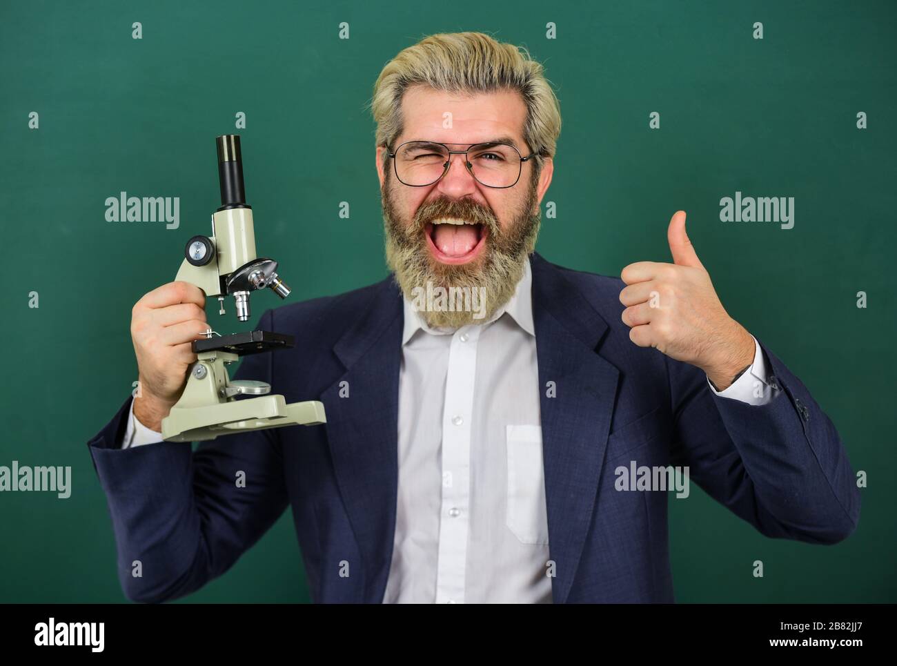 Scientific research. Teacher with microscope. Man hipster classroom ...