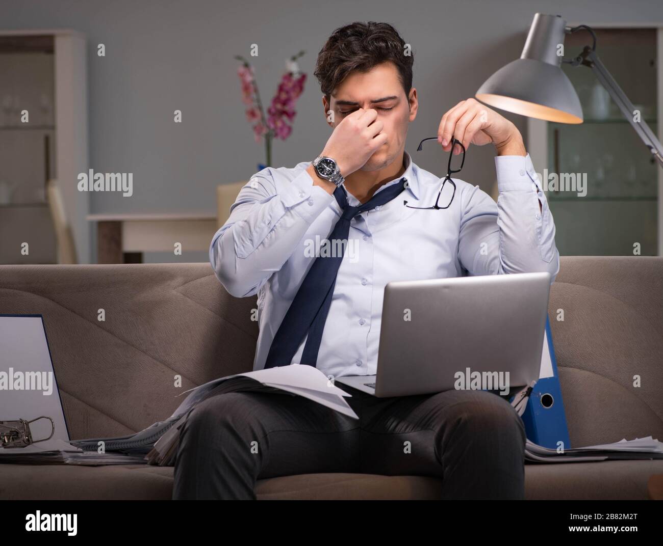 The businessman workaholic working late at home Stock Photo - Alamy