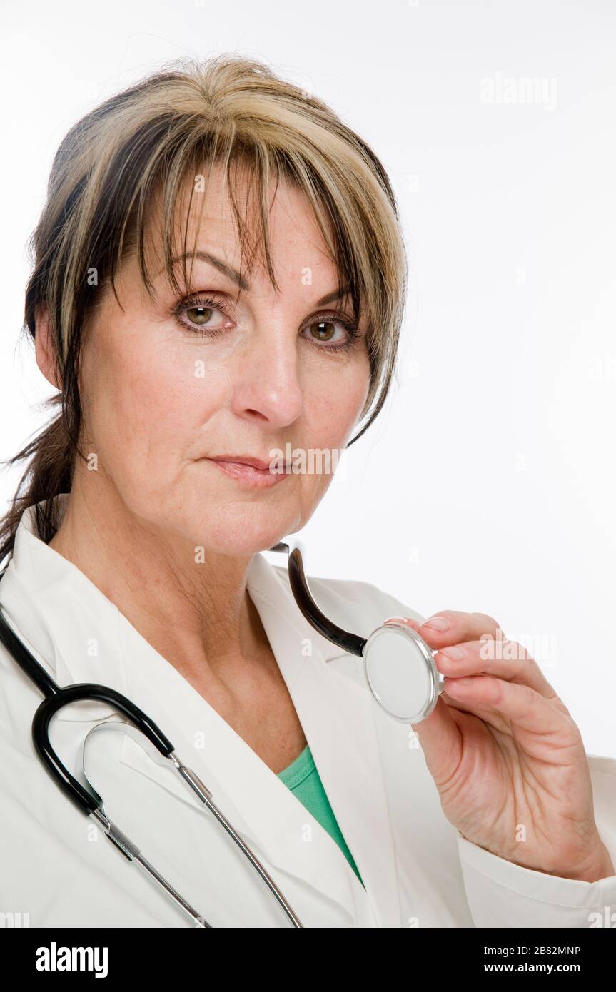 Head and shoulder portrait of a female doctor in white coat and ...