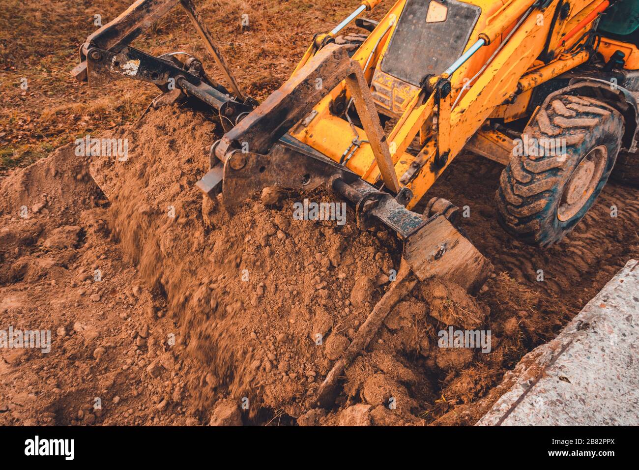 Excavator with a large iron bucket on a construction site during road ...
