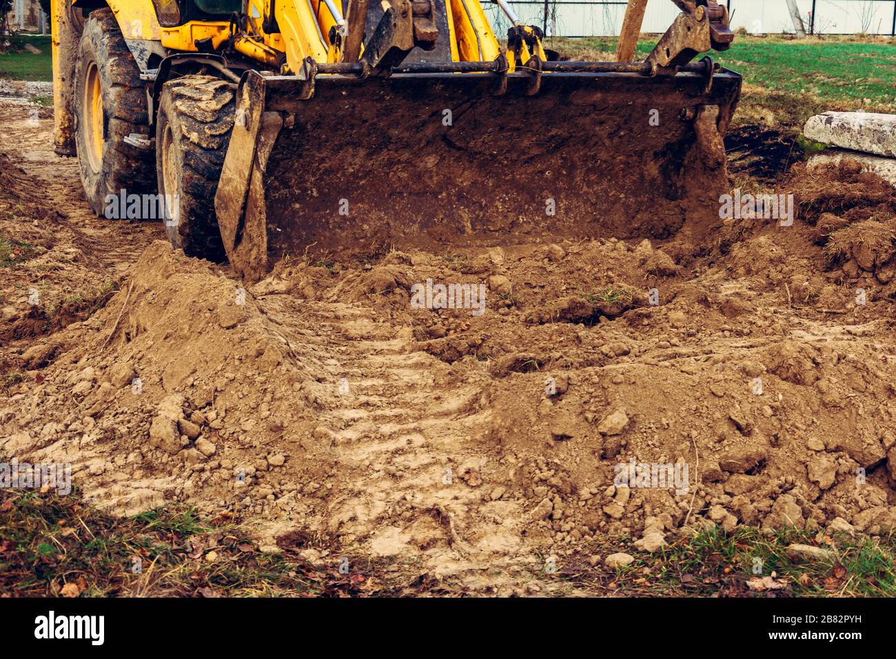 Excavator with a large iron bucket on a construction site during road ...