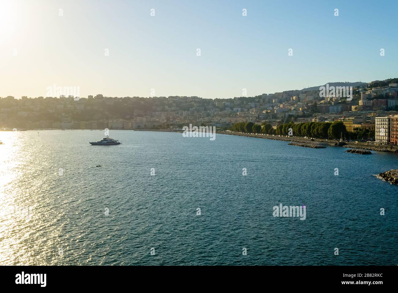 Panoramic view from the waterfront of Naples, Italy. The sunset warm ...