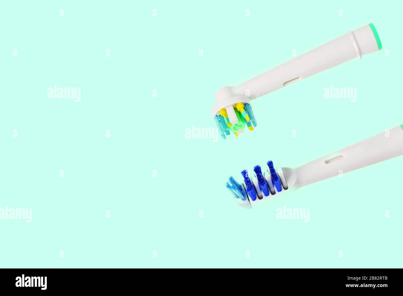 Two kinds of head for toothbrush close up view isolated on blue ...