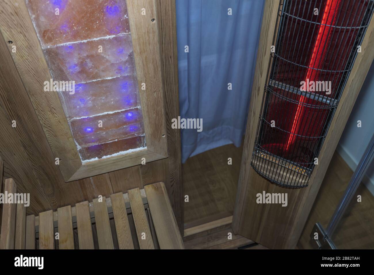 Infrared sauna interior close up view. Wooden walls and bench, ceramic ...