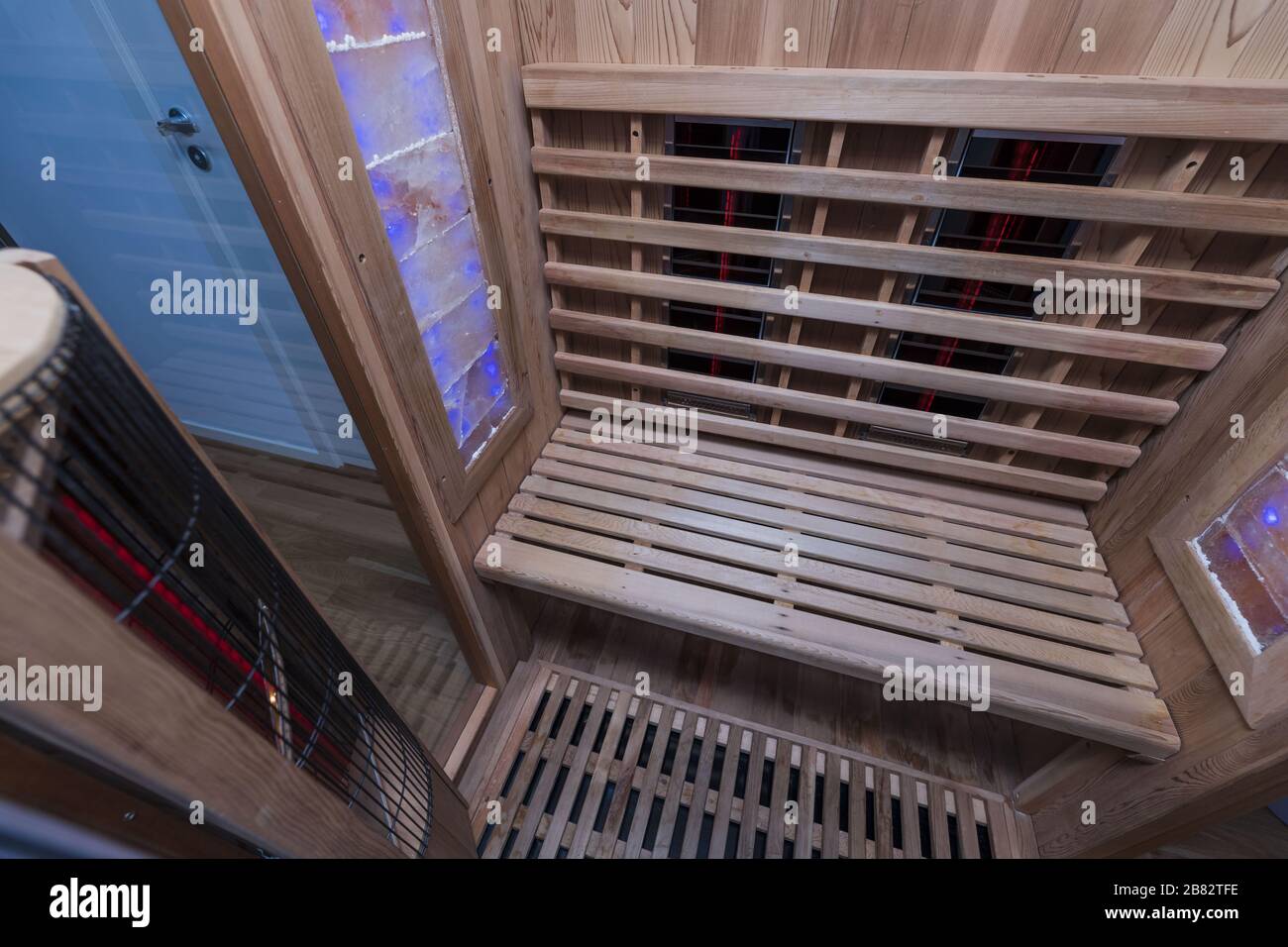Infrared sauna interior close up view. Wooden walls and bench, ceramic ...