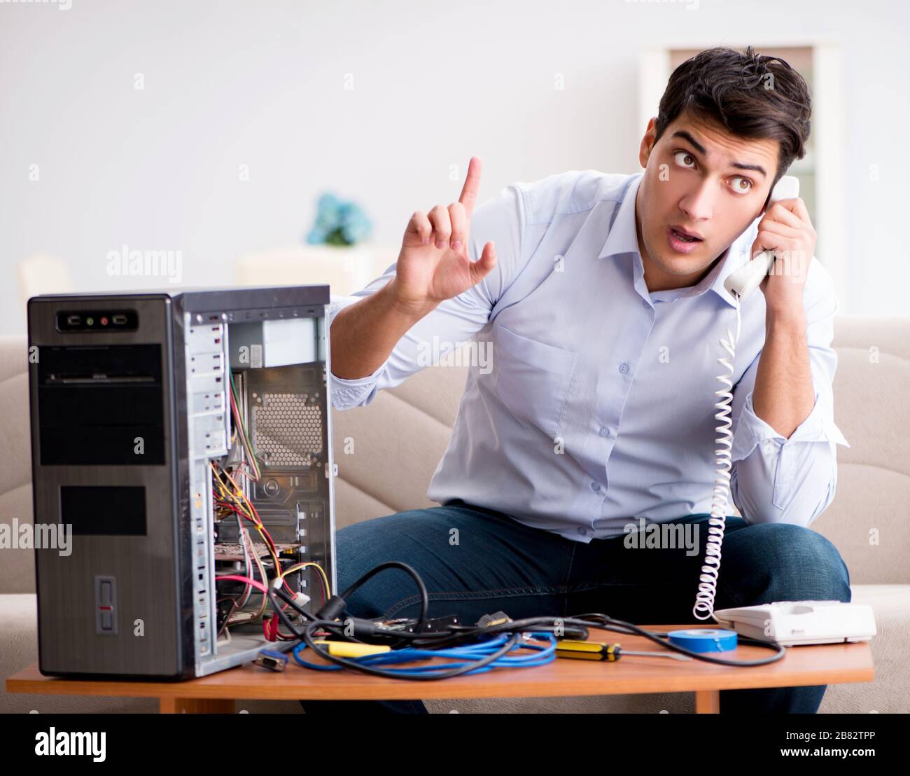 The angry customer trying to repair computer with phone support Stock ...