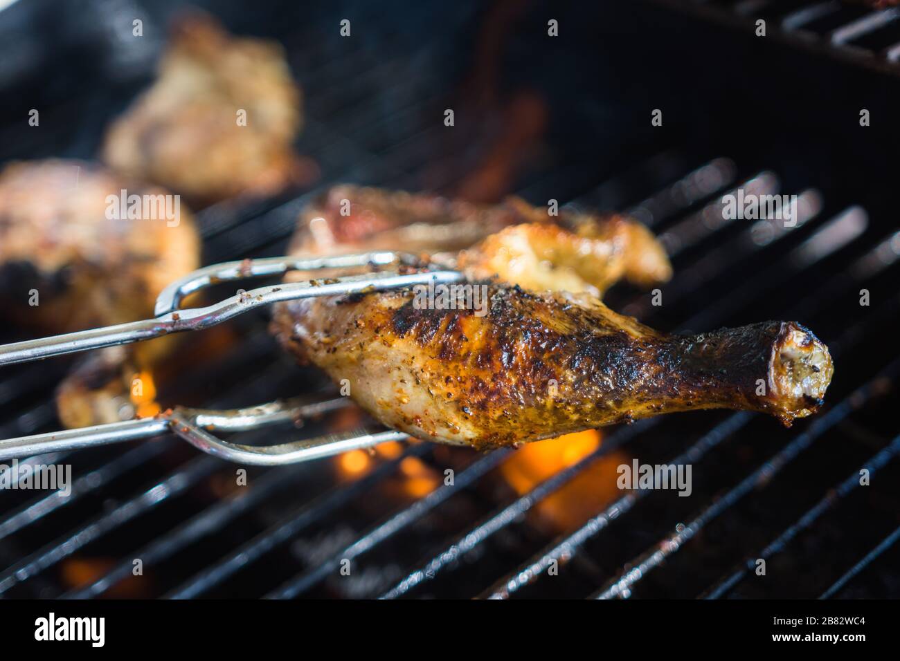 Chicken and burgers flame cooked on outdoor gas grill Stock Photo - Alamy