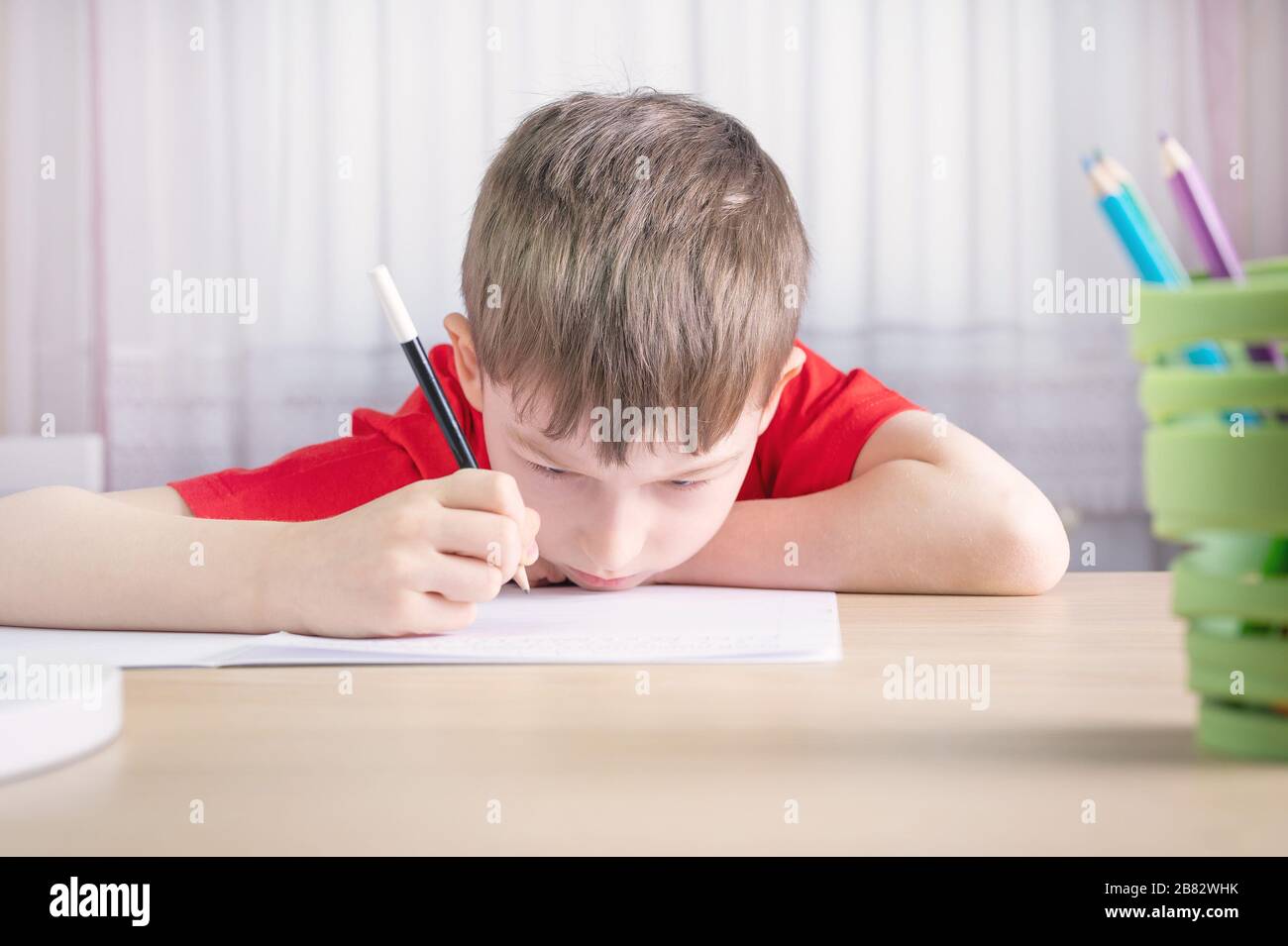 the boy does not want to do homework for school Stock Photo - Alamy