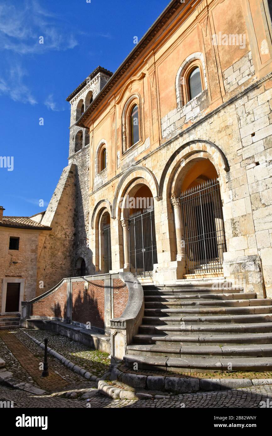 A narrow street between the old houses of Veroli, a medieval village in ...