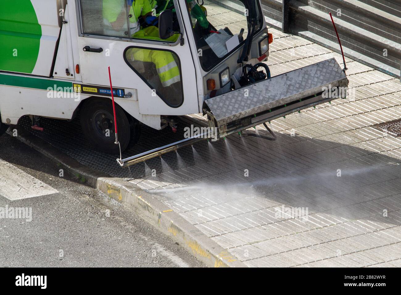 Street cleaning machine working in city. Sweeper cleaning the sidewalk ...