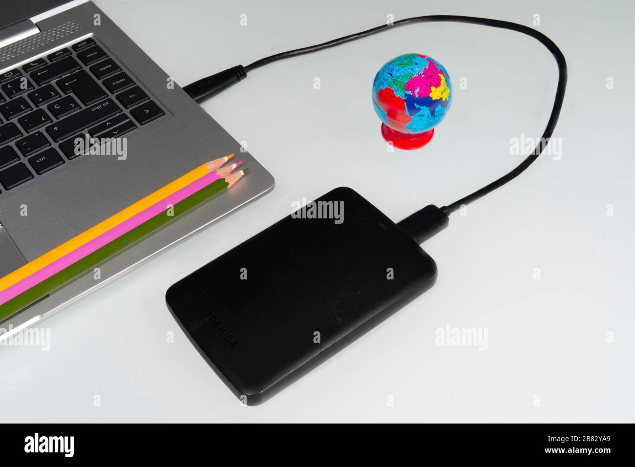 desktop with world and hard disk connected to a computer through the ...