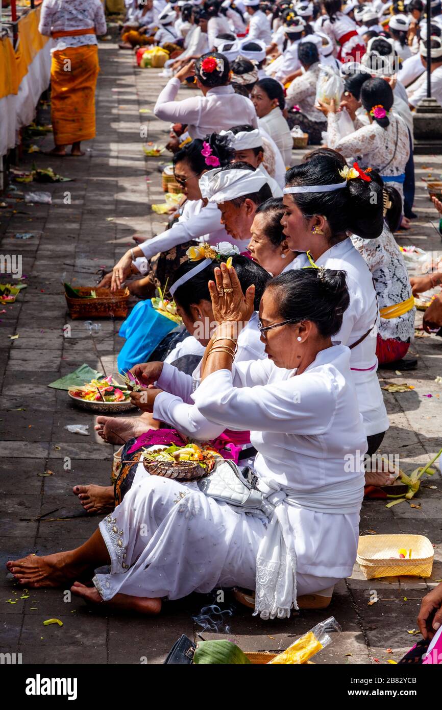 Balinese Hindu People Praying During The Batara Turun Kabeh Ceremony ...