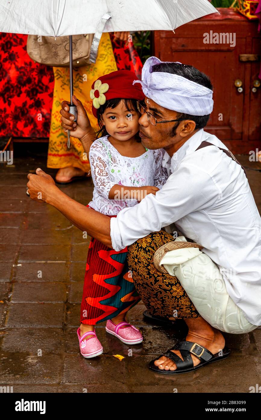 A Group Of Balinese Hindu People At The Batara Turun Kabeh Ceremony In ...