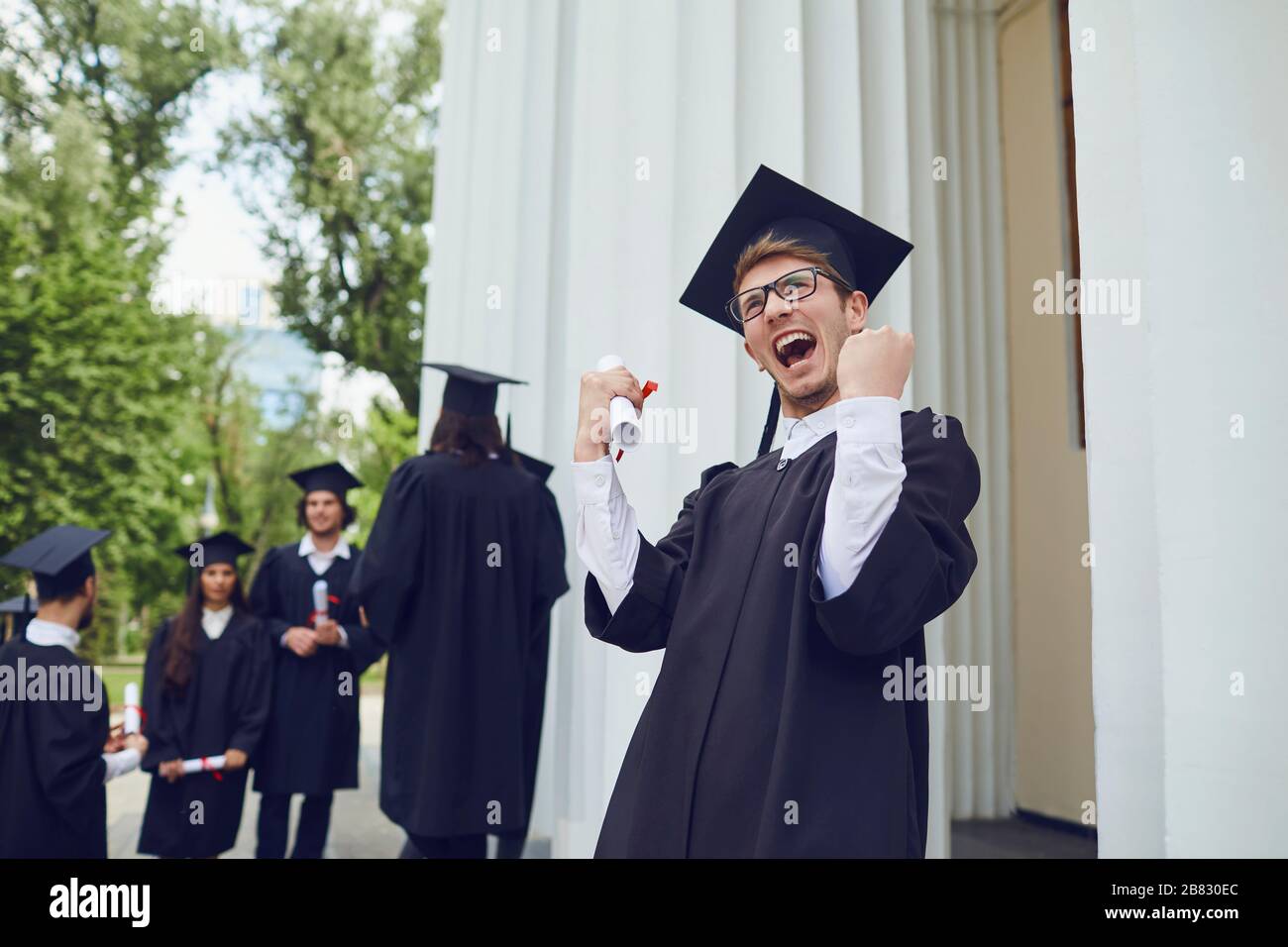 Male college graduate with diploma hi-res stock photography and images ...