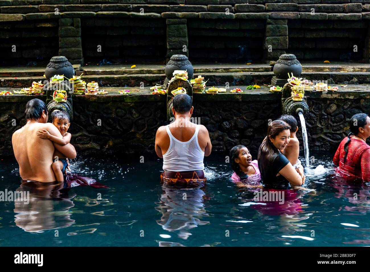 Balinese Visitors Bathing In The ‘Holy Spring’ Pool During A Hindu ...