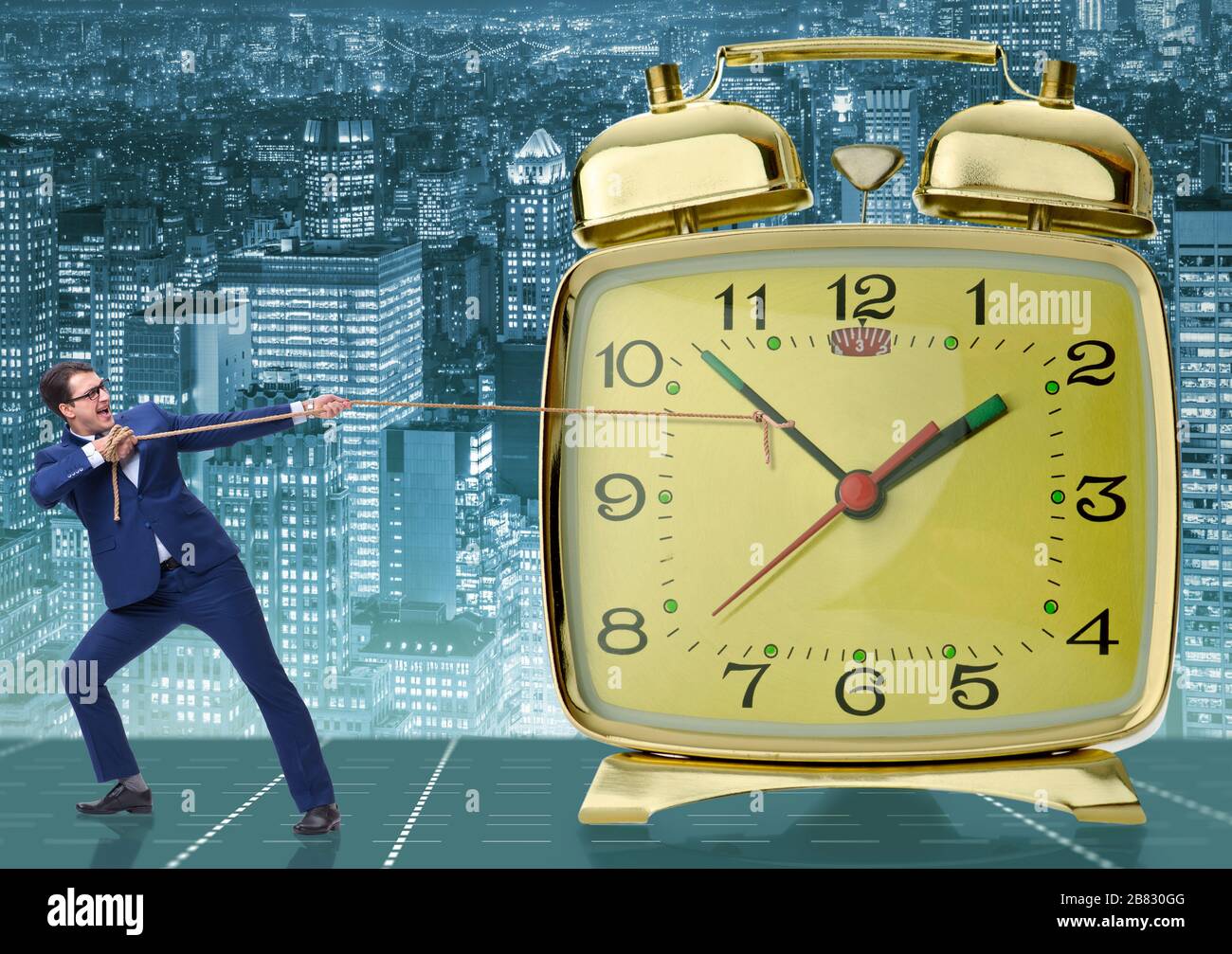 The businessman pulling clock in time management concept Stock Photo ...