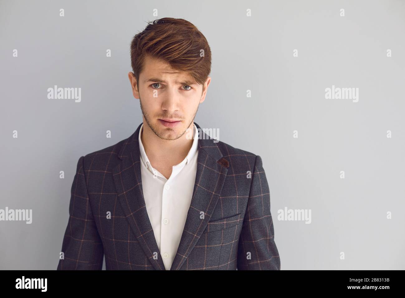 Serious young man suit hi-res stock photography and images - Alamy