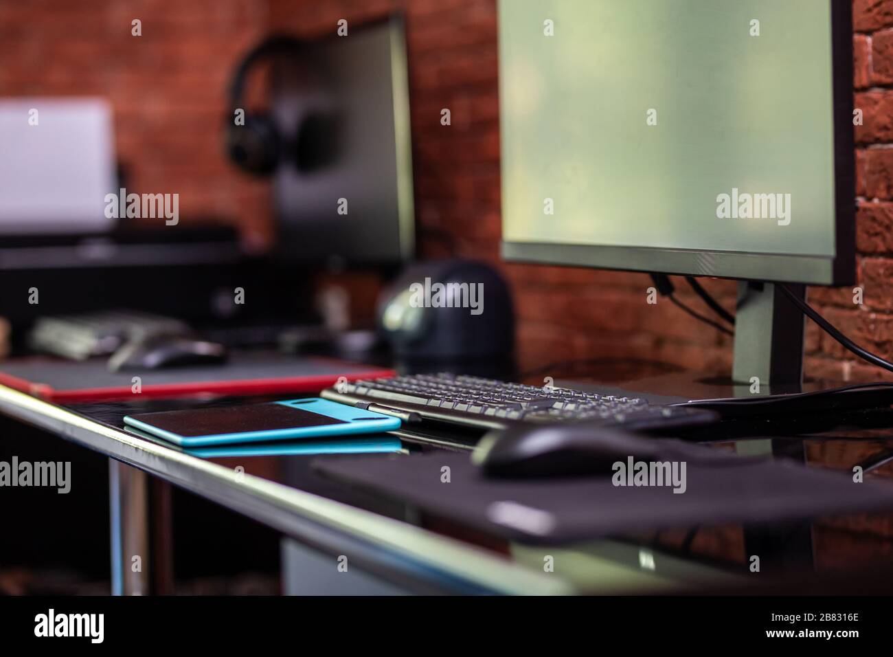 Two computer monitors with black screen on a desk, one workplace on ...