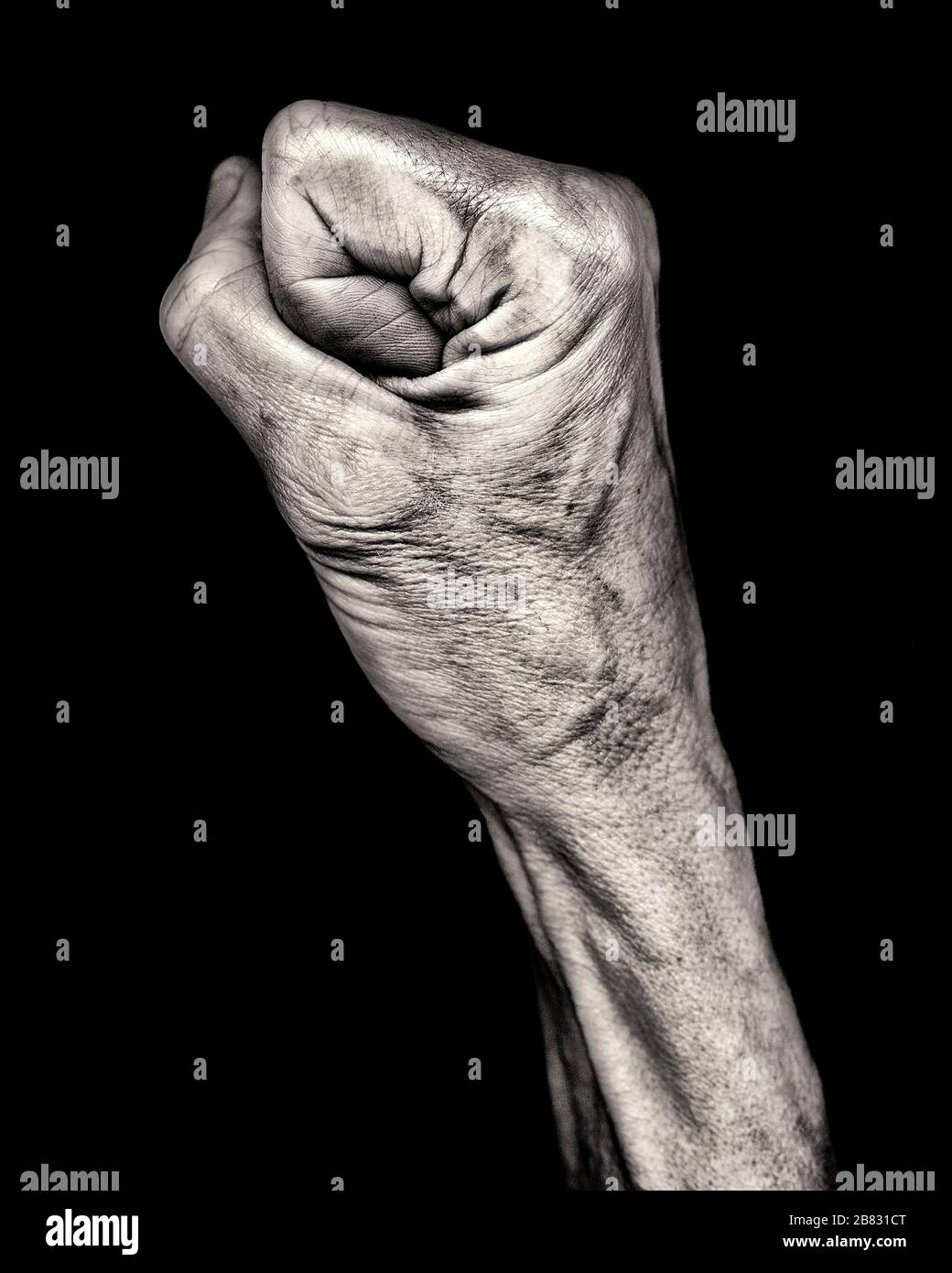 Mid-Adult Woman's Clenched Fist against Black Background, Profile View ...