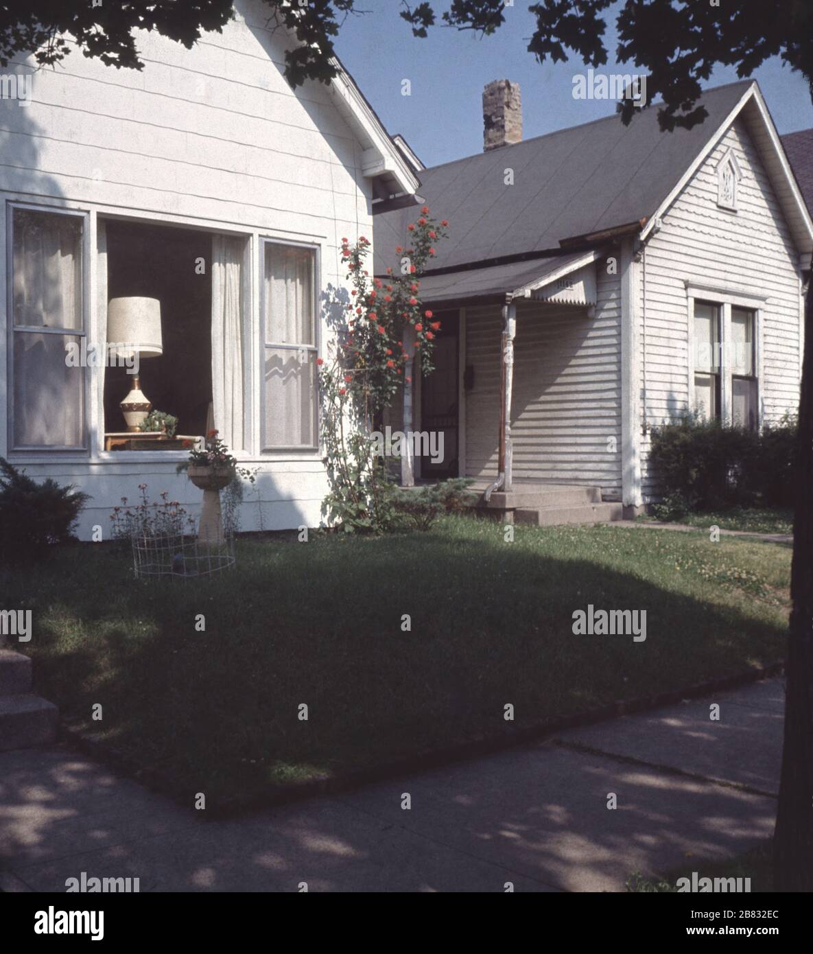 View of small suburban homes or cottages along a street, with sidewalks ...