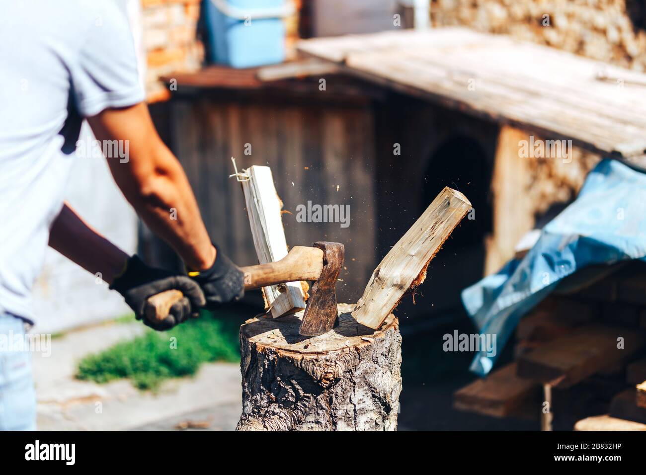 Ready for cutting timber. Close-up of axe cutting log while other logs ...