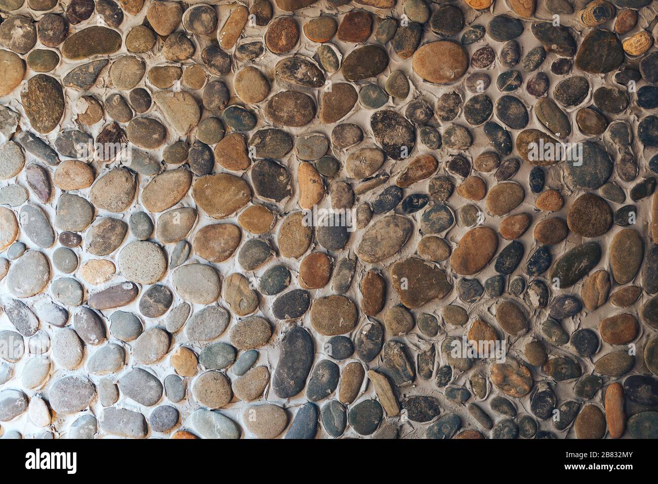 Background texture of different round stone wall Stock Photo - Alamy