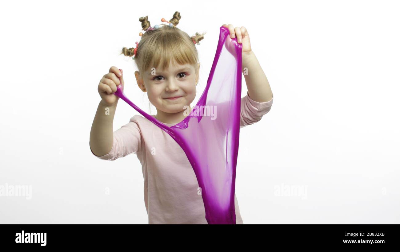 Child having fun making purple slime. Kid playing with hand made toy ...