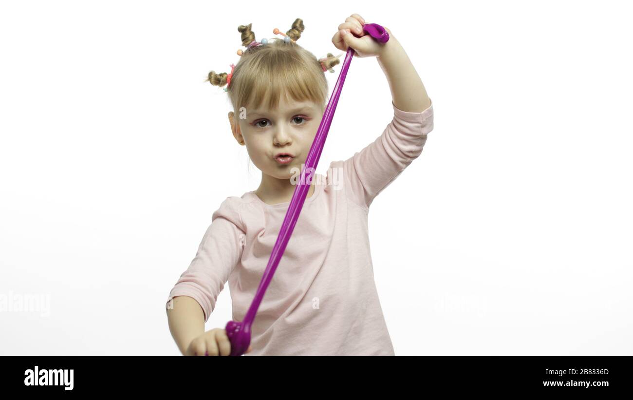 Child having fun making purple slime. Kid playing with hand made toy ...