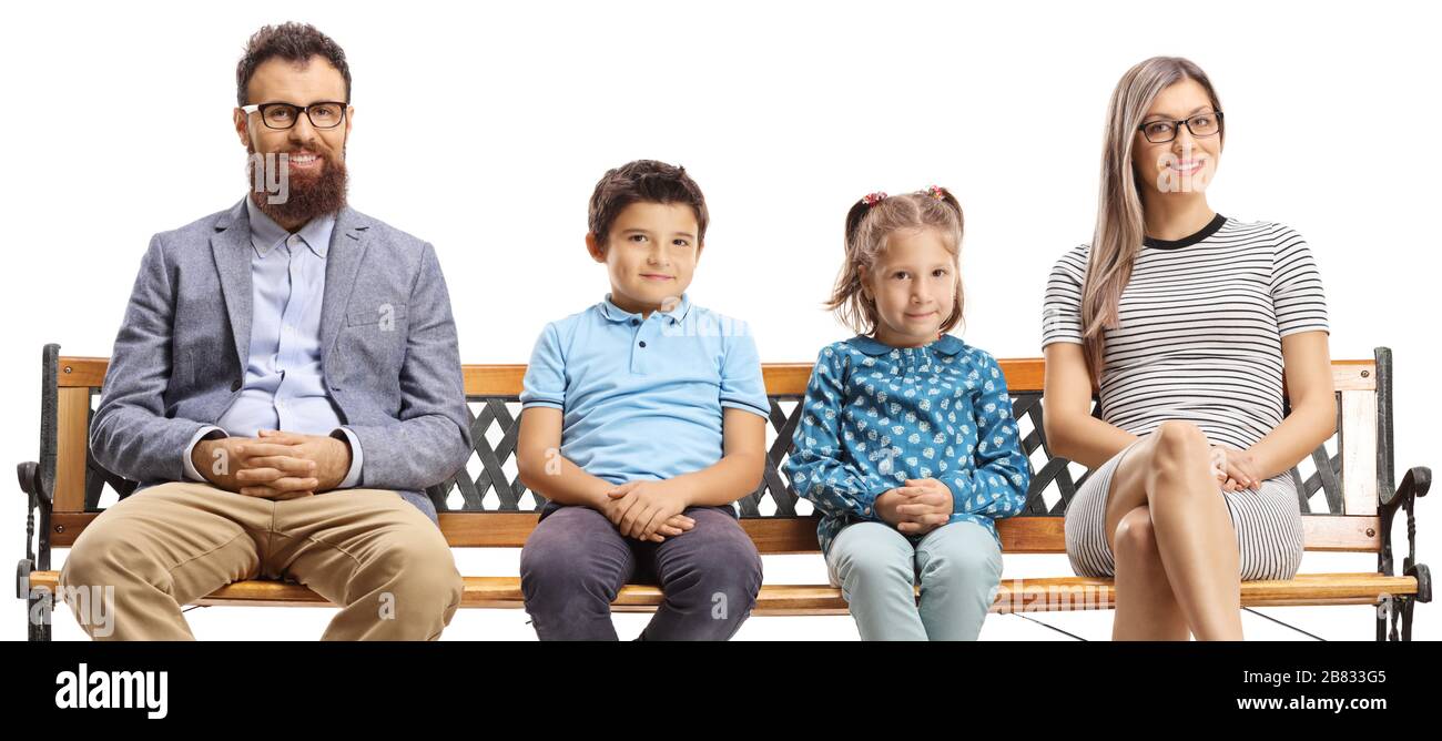 Parents and children sitting on a bench and looking at the camera ...