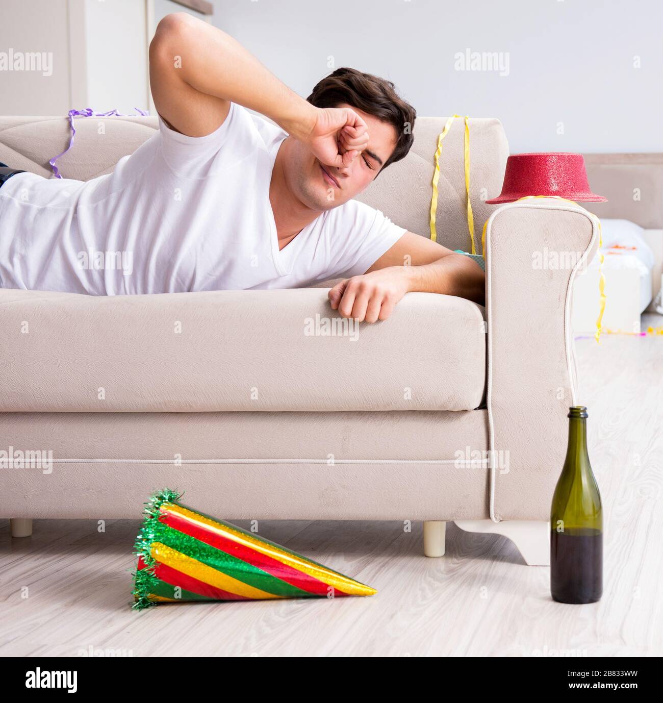 The man at home after heavy partying Stock Photo - Alamy