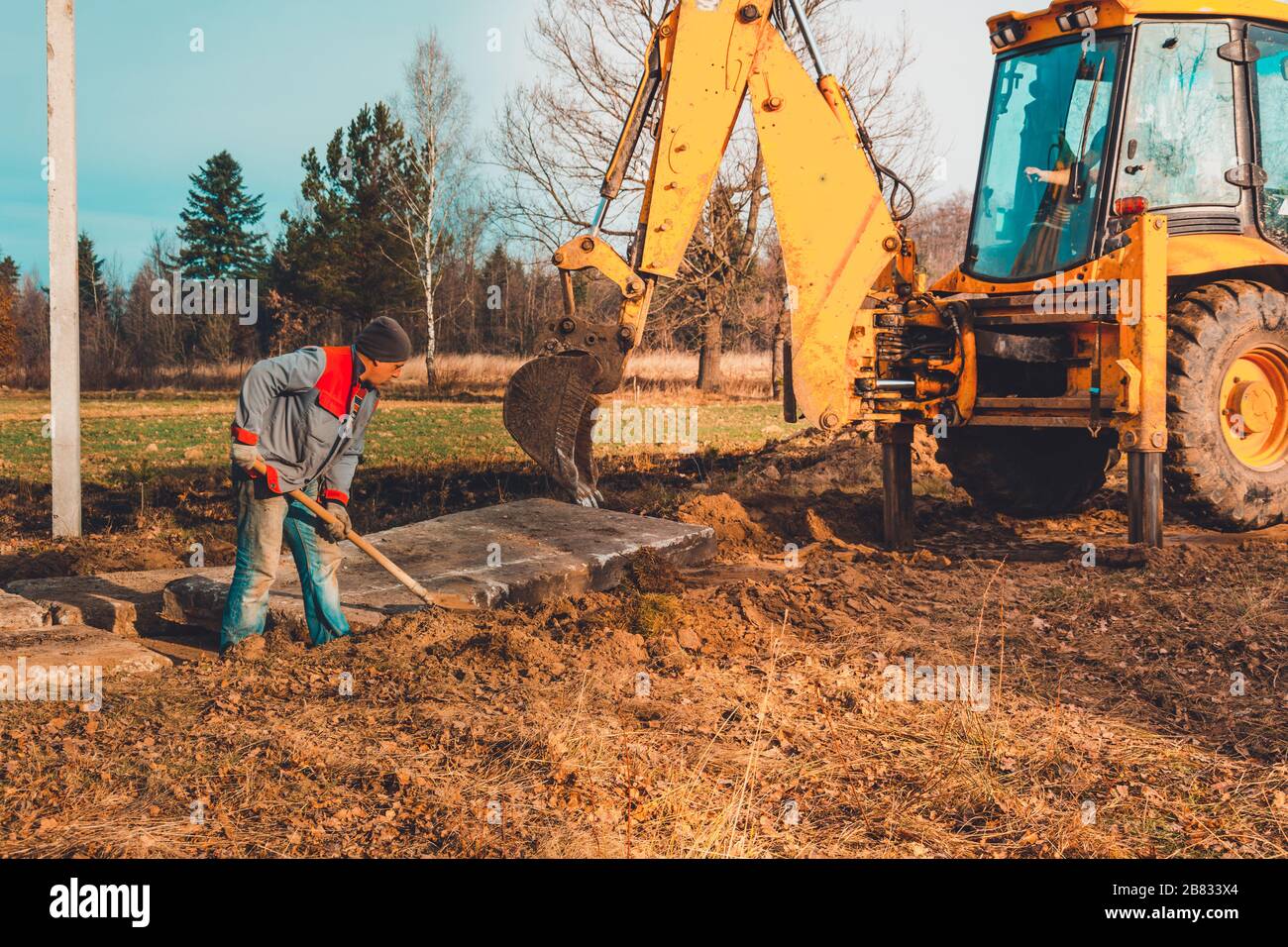 The bucket excavator pulls up concrete slabs to set the road Stock ...