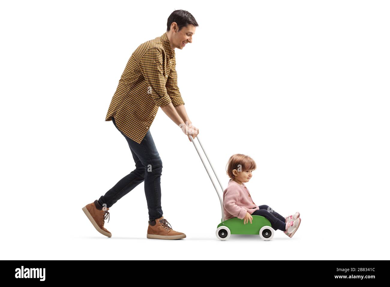 Full length profile shot of a young man smiling and pushing a toddler ...