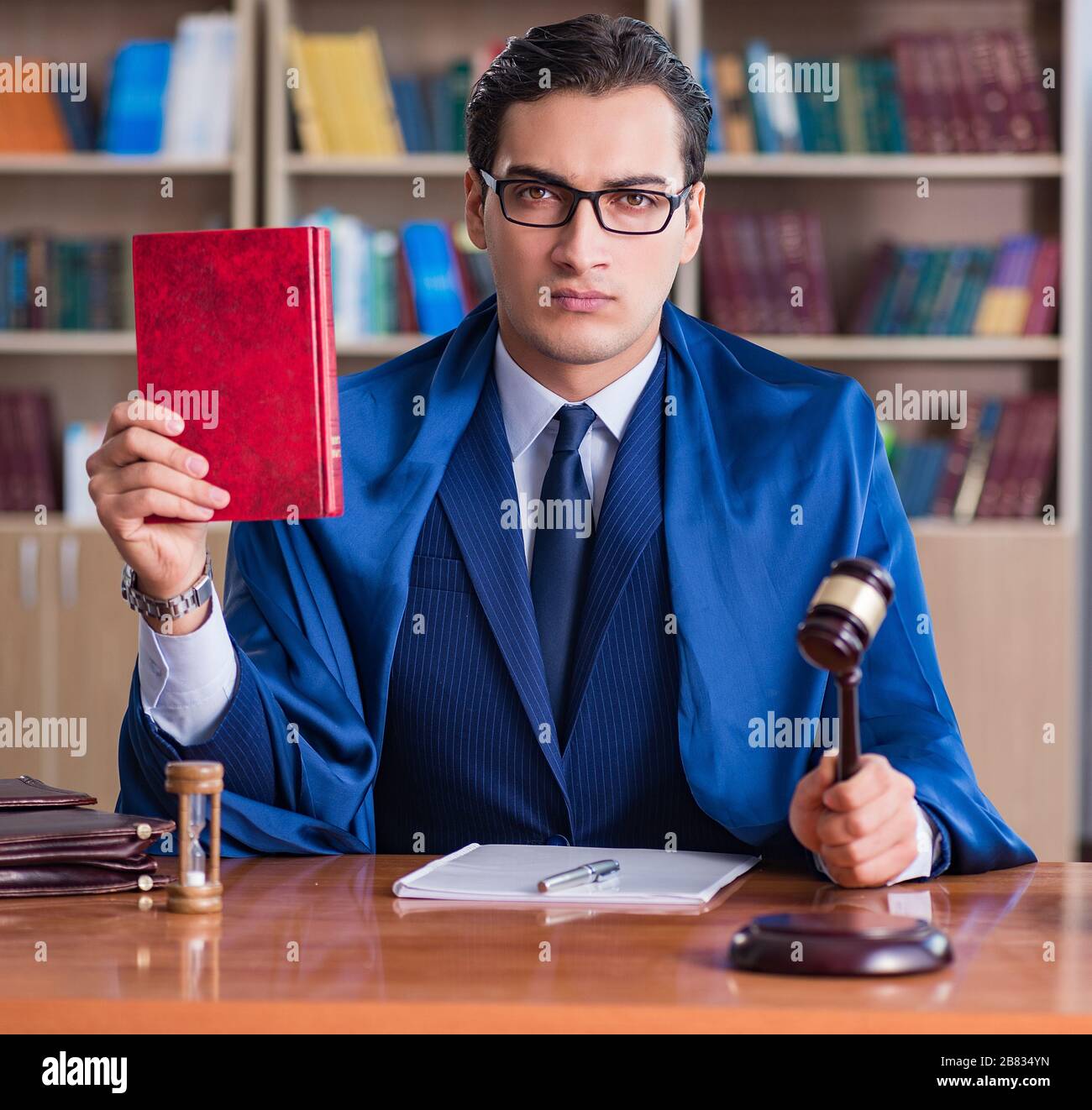 The handsome judge with gavel sitting in courtroom Stock Photo - Alamy