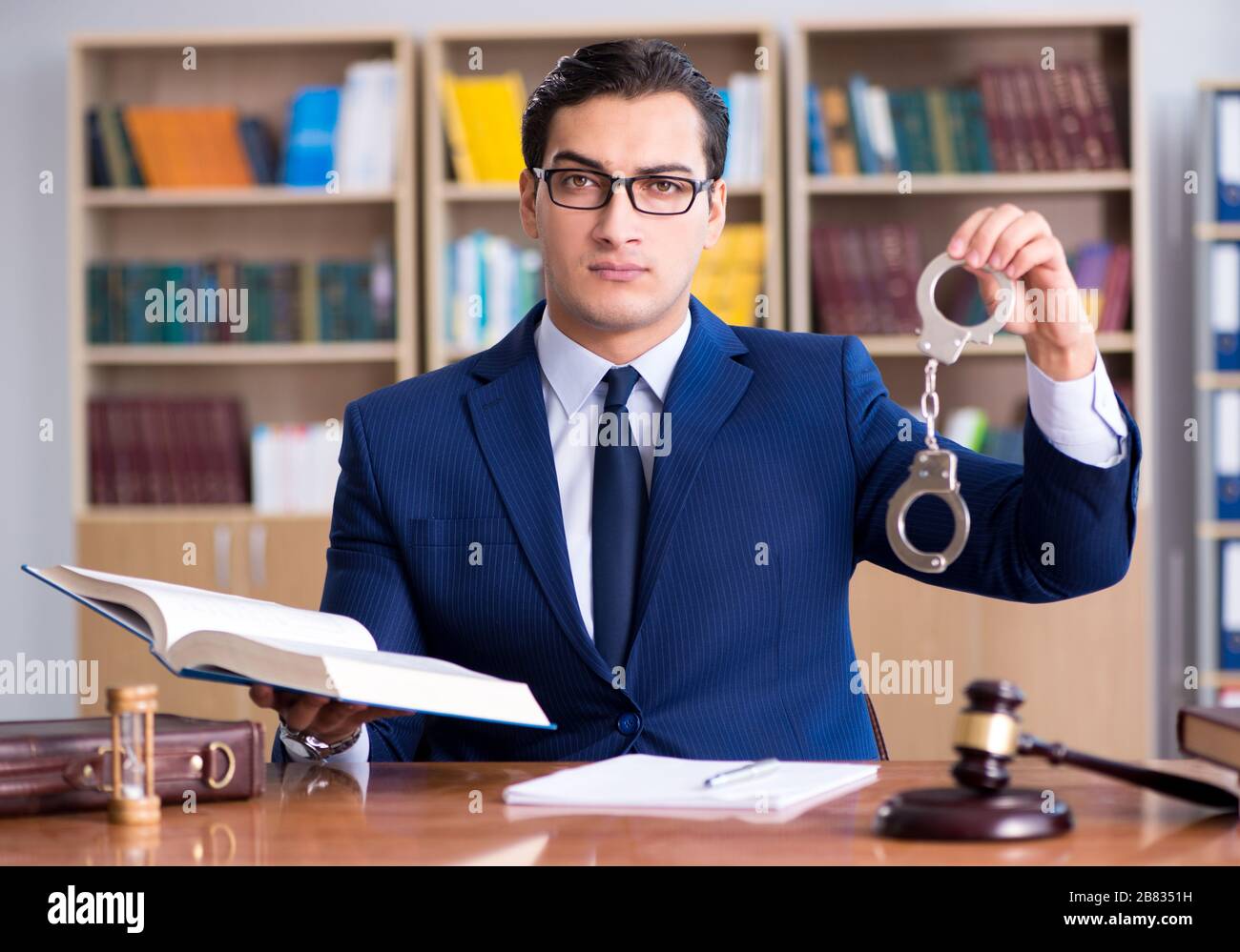 The handsome judge with gavel sitting in courtroom Stock Photo - Alamy