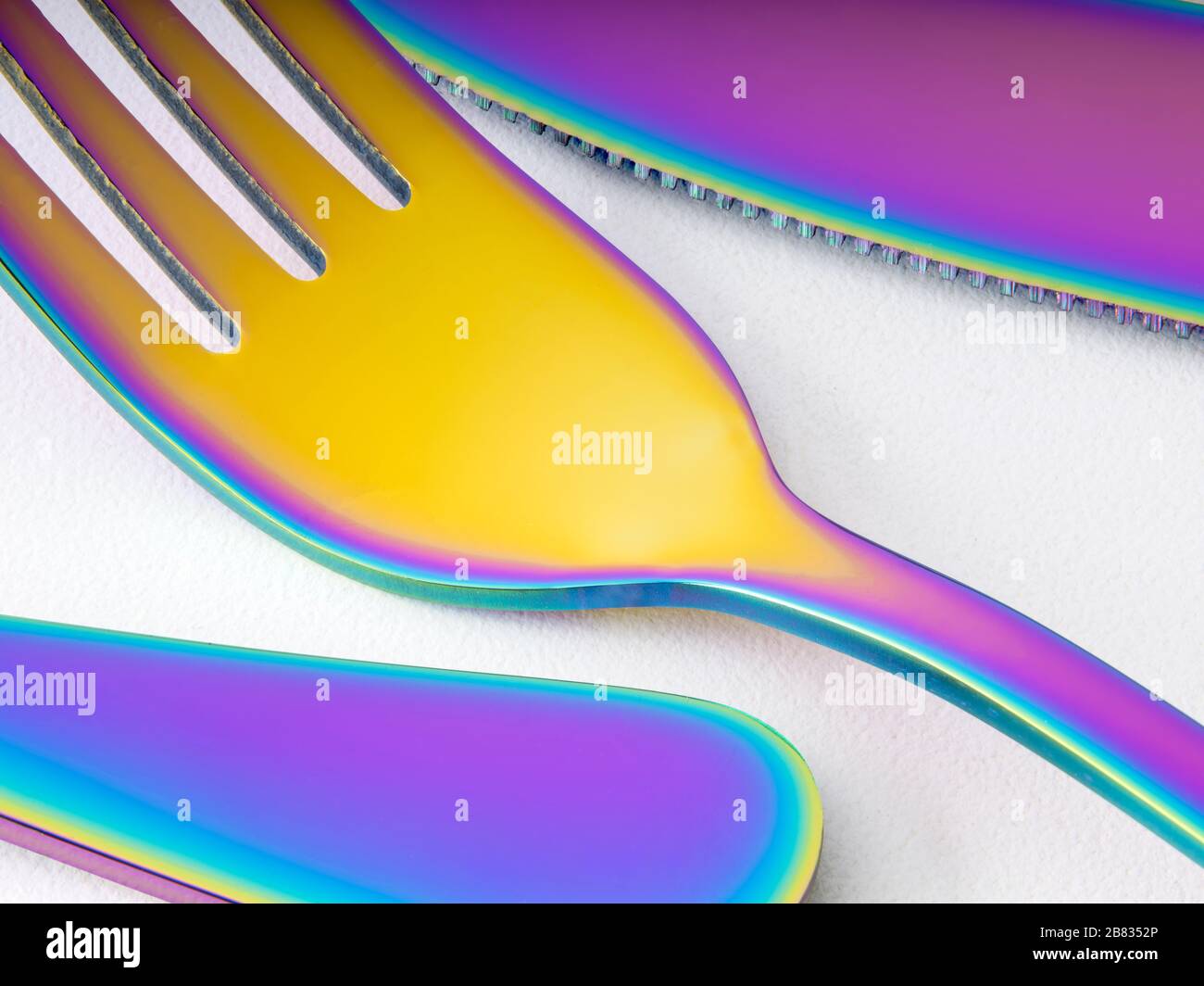 Colorful fork detail on white background Stock Photo - Alamy