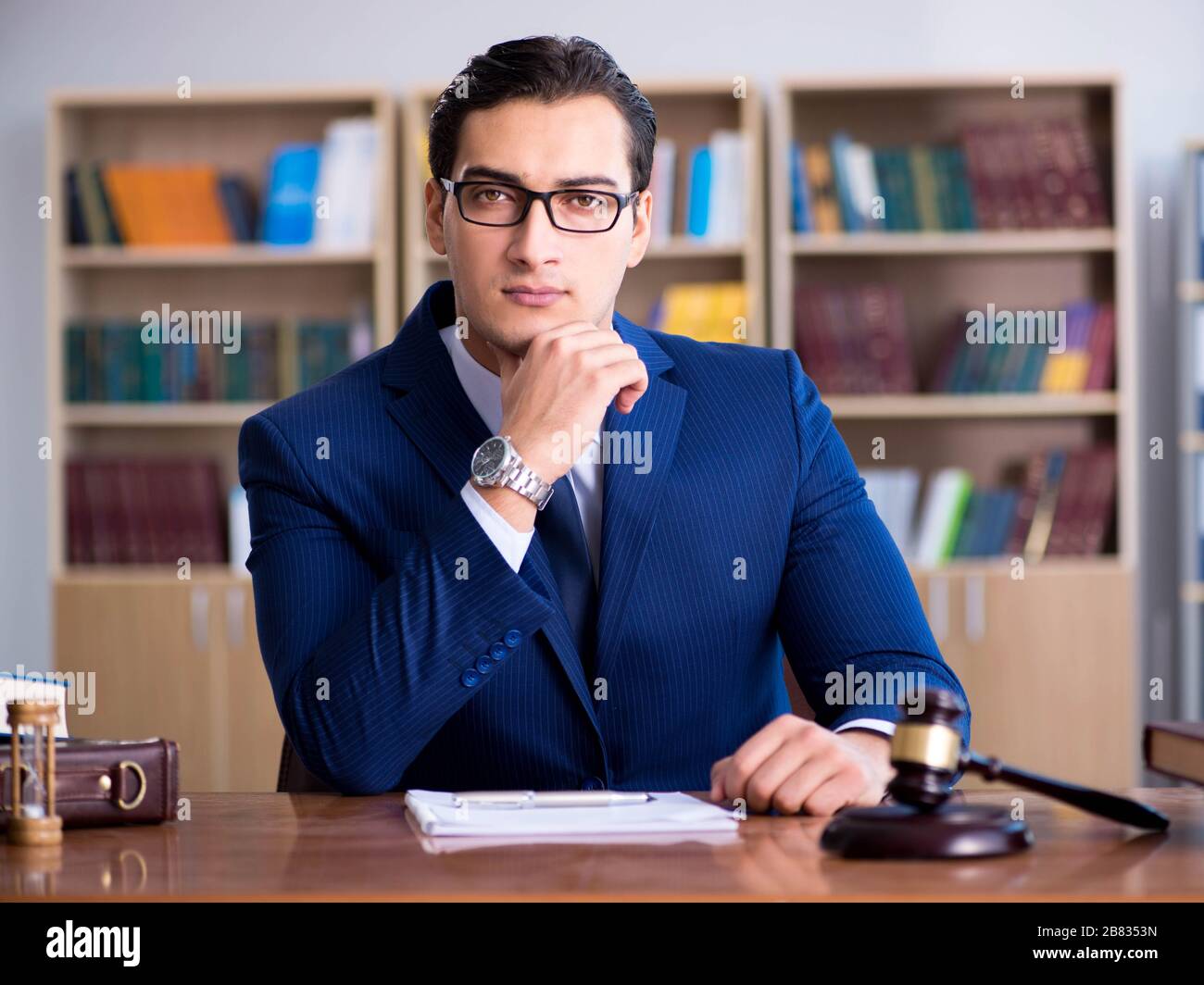 The handsome judge with gavel sitting in courtroom Stock Photo - Alamy